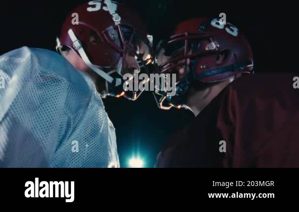 A dramatic moment as two American football players face off, helmets ...