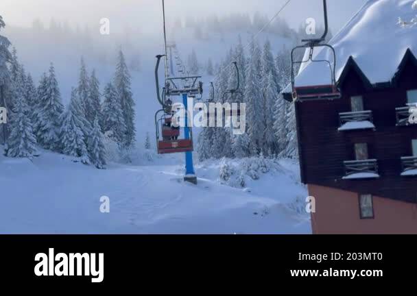 A ski lift in a snowy forest close-up Stock Video Footage - Alamy