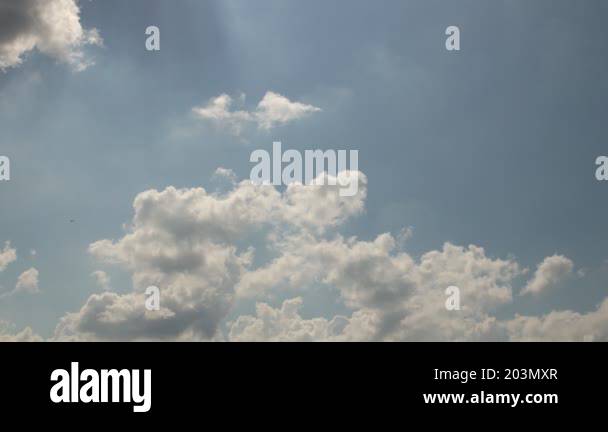 Clear blue sky with cumulus clouds that stand still and cirrus clouds ...