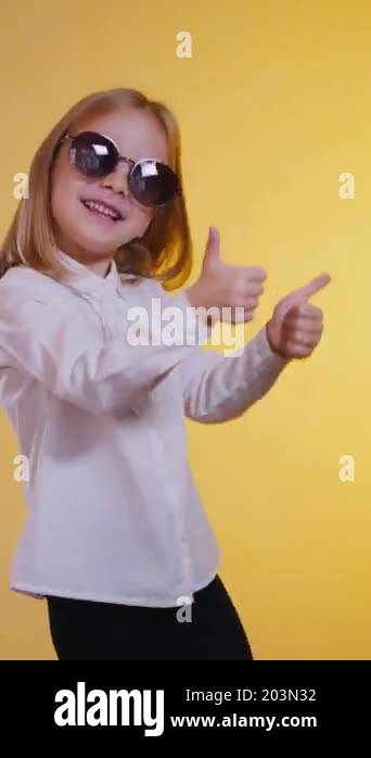 Vertical, Young business girl giving thumbs up and cheerfully laughing ...