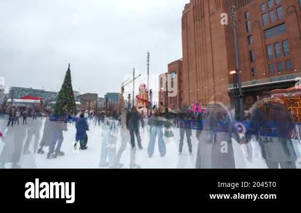 People enjoy ice skating near a large Christmas tree by the Tate Modern ...