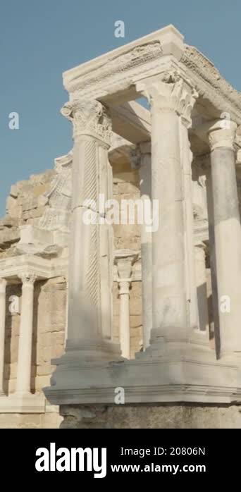 Vertical video. An ancient Roman structure with towering white marble ...