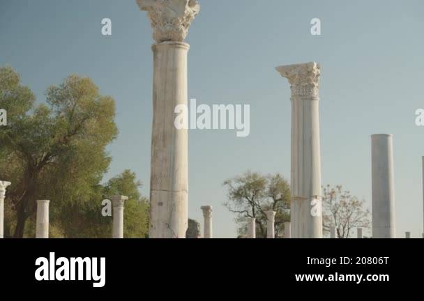 A row of white marble columns from an ancient ruin in a straight line ...