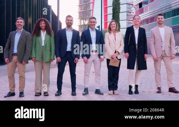 Professional team of diverse individuals standing confidently with arms ...