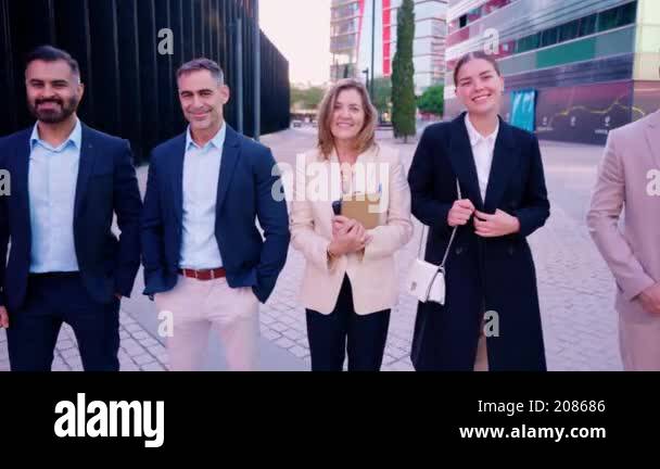 Professional team of diverse individuals standing confidently with arms ...