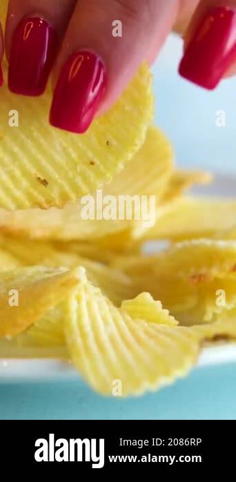 A person holding a bowl of potato chips. couch chewing potato chips ...