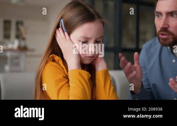 Anxious guilty Caucasian daughter schoolgirl child closing ears annoyed ...