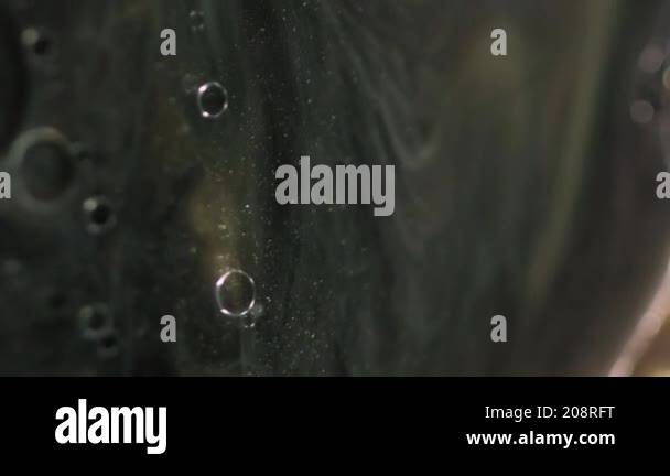 Luxury ink. Shimmer paint. Defocused black golden color floating ...