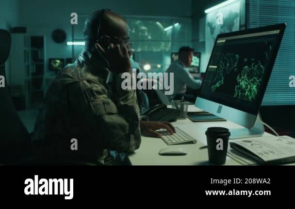 Medium side shot of African American male military satellite operator ...