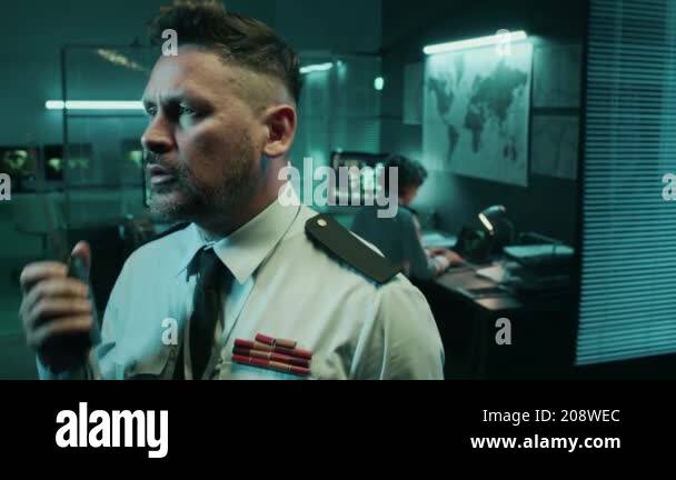 Medium closeup of agitated Caucasian male army general major talking on ...