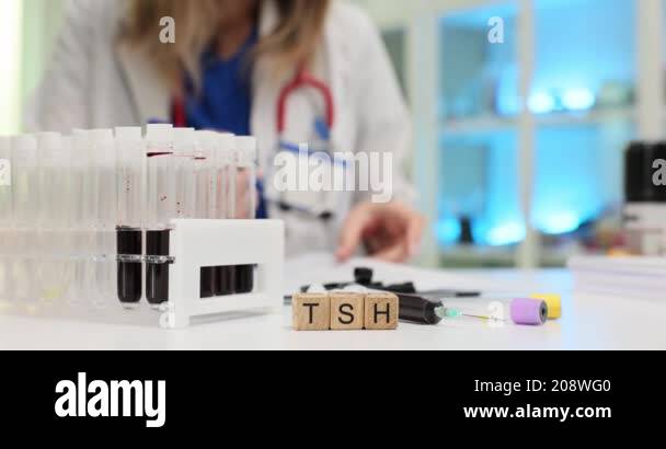 A trained professional in a medical laboratory handling TSH blood ...