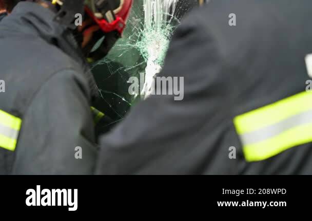 Firefighters work on an extrication using a hydraulic rescue tool. High ...
