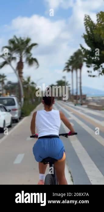 A cyclist is happily enjoying a sunny ride along a beautiful and scenic ...