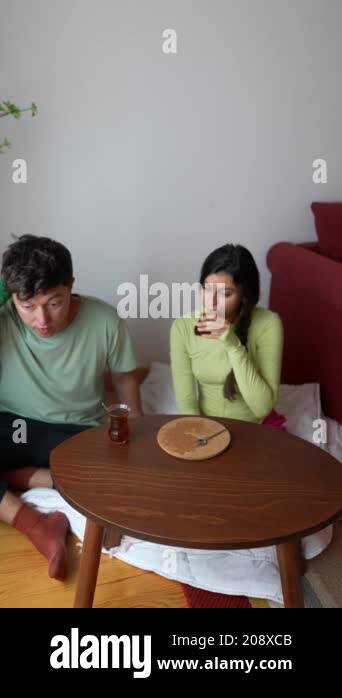 In a relaxed and cozy atmosphere, friends are joyfully enjoying ...