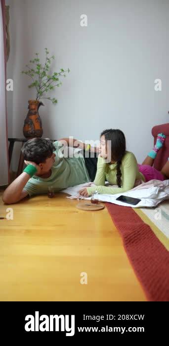 Two good friends are relaxing together at home, enjoying a fun and ...