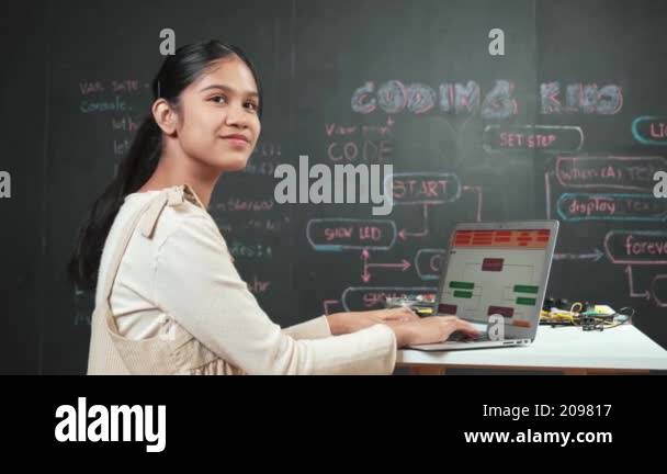 Smart girl using laptop coding or programming system at blackboard ...