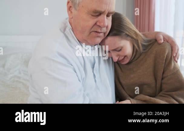 Loving older father comforting upset crying adult daughter, hugs and ...