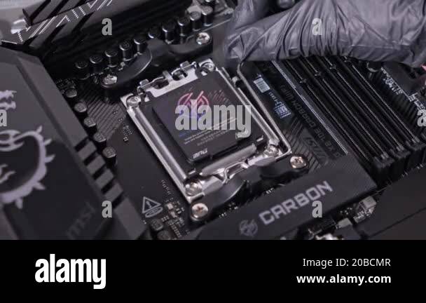 Poznan, Poland - November 25, 2024: Removing the protective cover from a CPU socket on an MSI ...