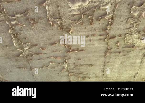 Concrete surface with beige peeling paint shows signs of long-term ...