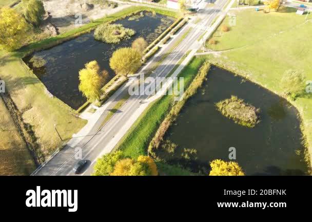 Aerial shot ponds road trees autumn landscape Stock Video Footage - Alamy