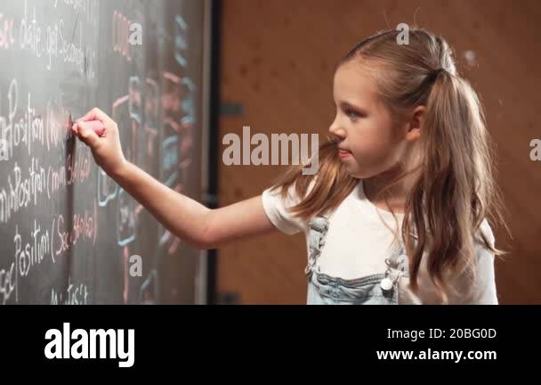 Panorama shot of girl writing engineering prompt on blackboard ...