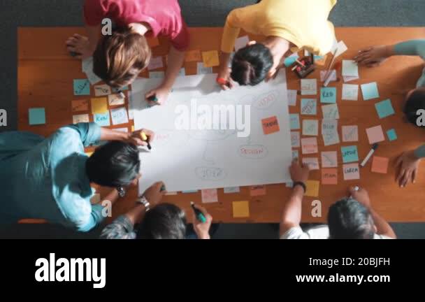 Top view of project manager writing and sticking stick notes. Aerial ...