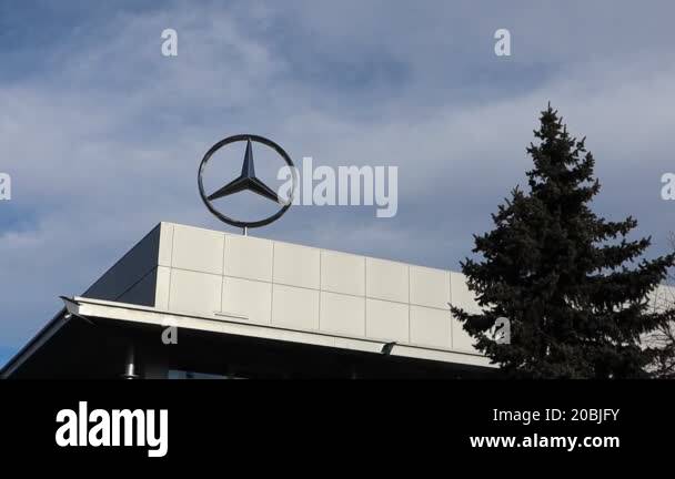 The wellknown MercedesBenz logo is prominently showcased on the facade ...