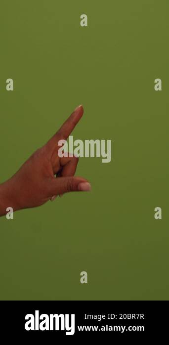 A closeup image of a human hand making a clear pointing gesture on a ...