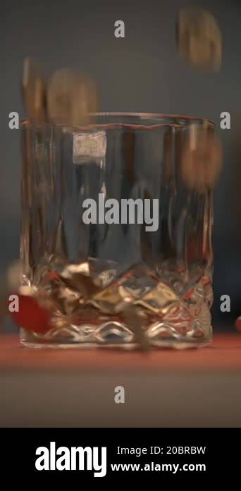 A stunning closeup of a clear glass illuminated beautifully by coins ...