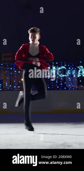 Vertical video, dancing on ice, man pro gymnast performs a trick on ice ...