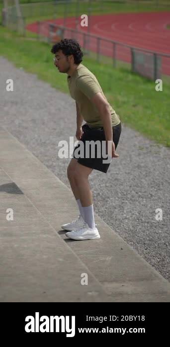 A young man is actively engaging in rigorous athletic training on a ...