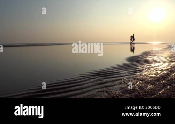 Beach landscape with morning sunrise, sunlight hitting the sand and ...
