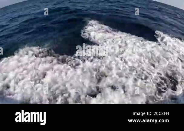 A close-view of Tidal waves captured from the boat over the deep blue ...