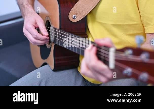 Musician hands pressing guitar strings, producing melodic sound during ...