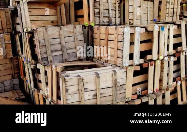 Empty wooden shipping crates stacked in a warehouse create an organized ...