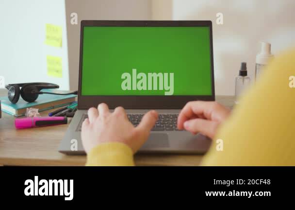 At home man typing on laptop with green screen work from home internet ...