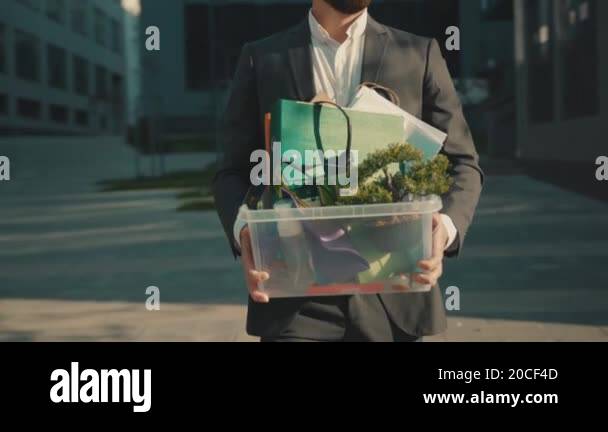 Sad office worker man stand look around with box of personal stuff lose ...