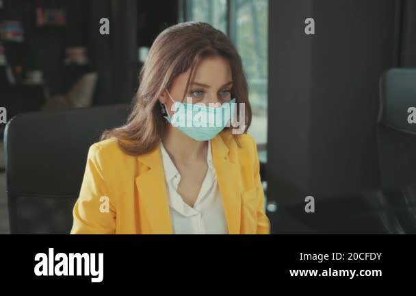 NEW YORK - March, 28, 2020: Woman office employee taking off medical ...
