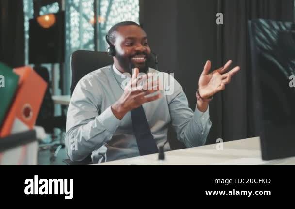 African American handsome man uses headphone for work speaking on ...