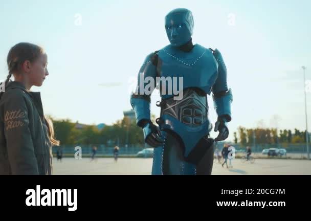 Close up humanoid robot stand with girl child on the street in the city ...