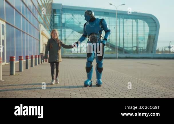 Girl walking with humanoid robot cyborg talking smiling child show an ...