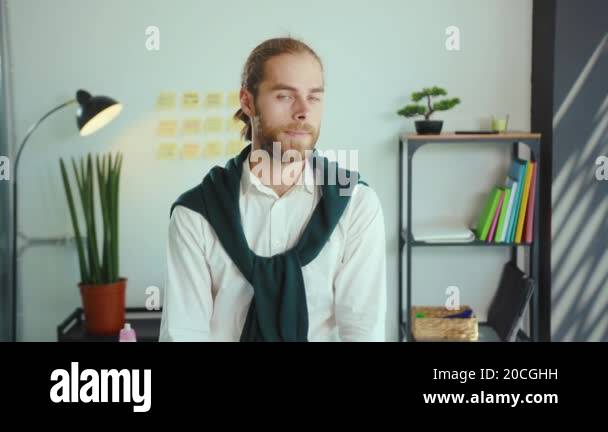 Portrait cheerful male boss with beard looking to camera in modern ...