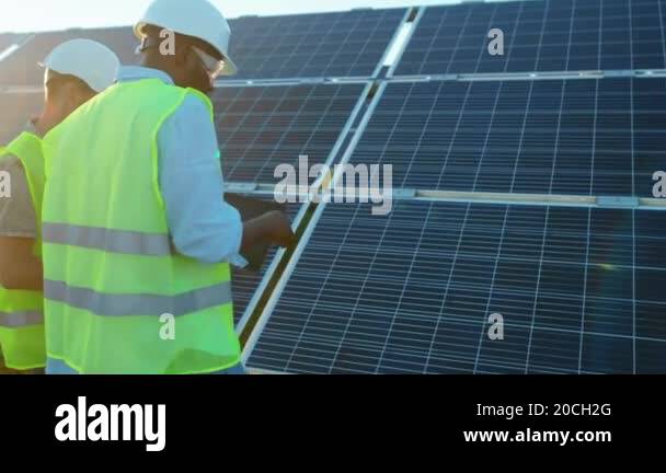 Slow motion engineer working use laptop stand near solar batteries ...