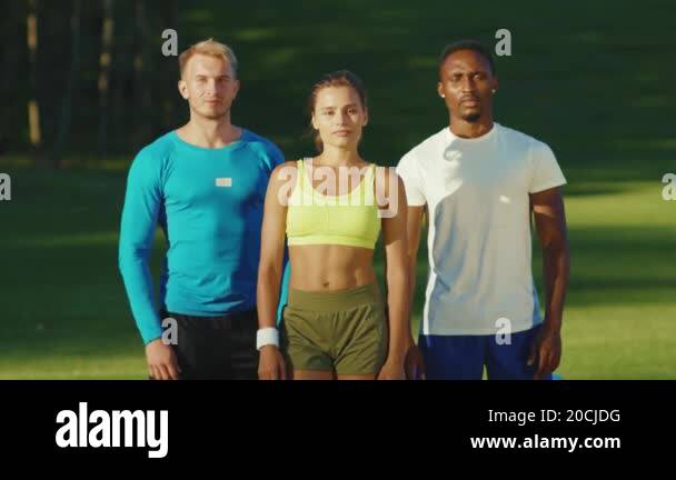 Group portrait of nice-looking healthy people in sports outdoors ...