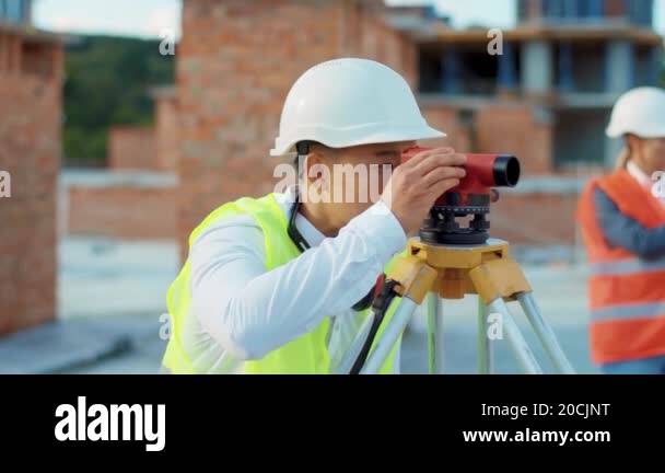 Slow motion asian man engineer surveyor takes measures with theodolite ...