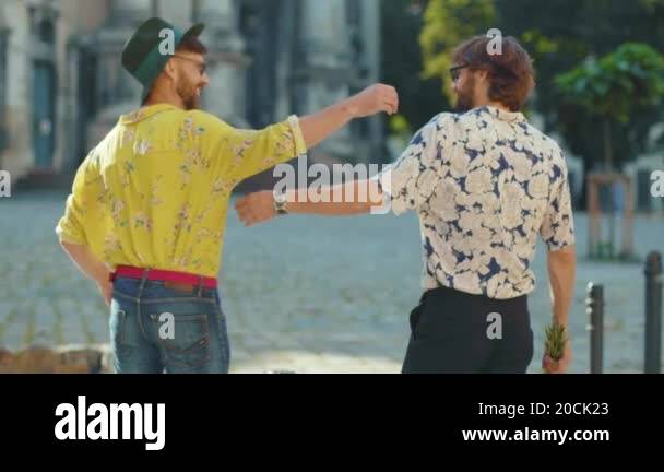 Shot back young gay couple hold hands hug each other walk at street ...