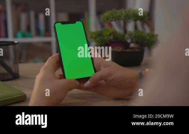NEW YORK - May 19, 2019: Girl Using Phone Vertical Green Screen Living Room Arri Alexa Mini ...