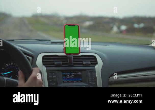 NEW YORK - April 5, 2019: Close up hands man drive car smartphone with ...