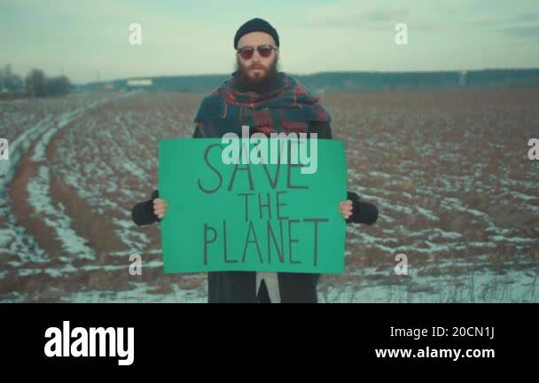 Portrait bearded man activist with Save the Planet ecology poster in ...