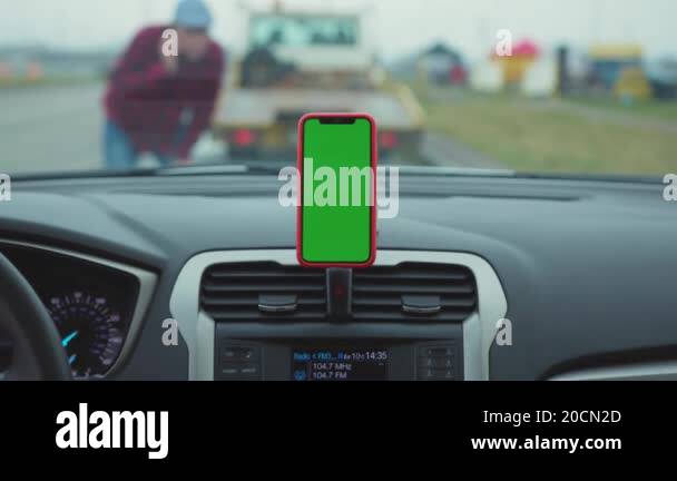 NEW YORK - April 5, 2019: Hands man drive car smartphone with green ...